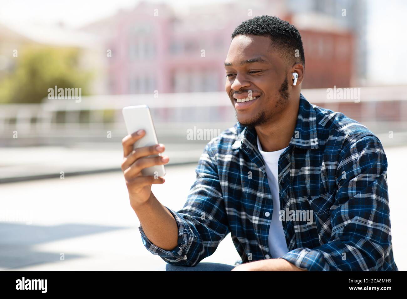 Portrait of african american guy watching video on cell phone Stock ...