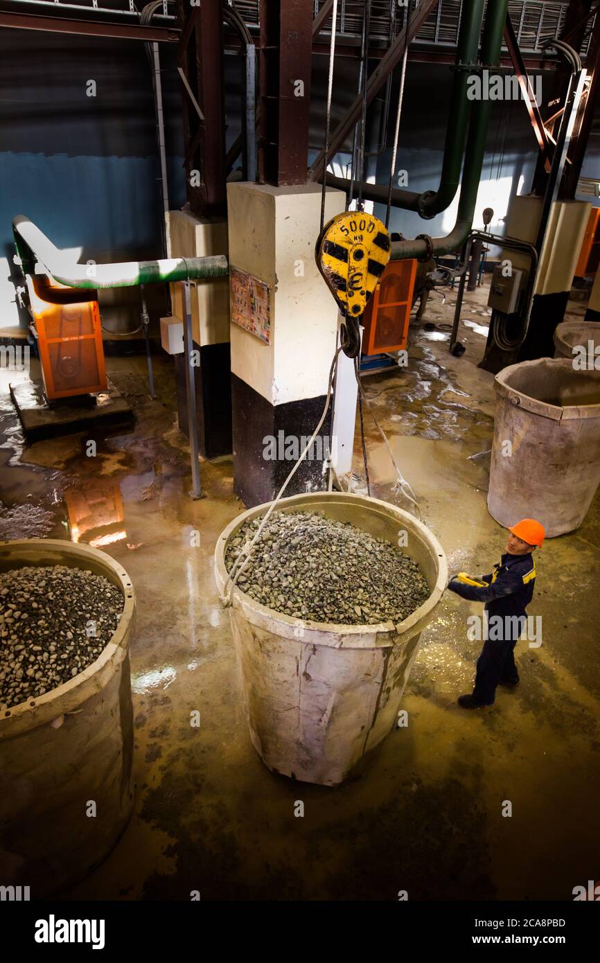Akbakay/Kazakhstan - April 23 2012: Factory worker with bucket of raw ...