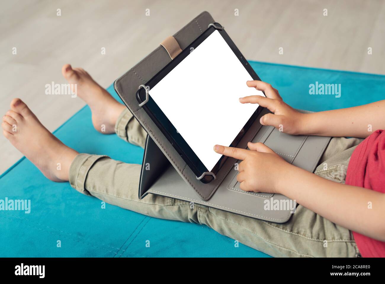 Hand of little child on a tablet. Tablet with white screen Stock Photo ...