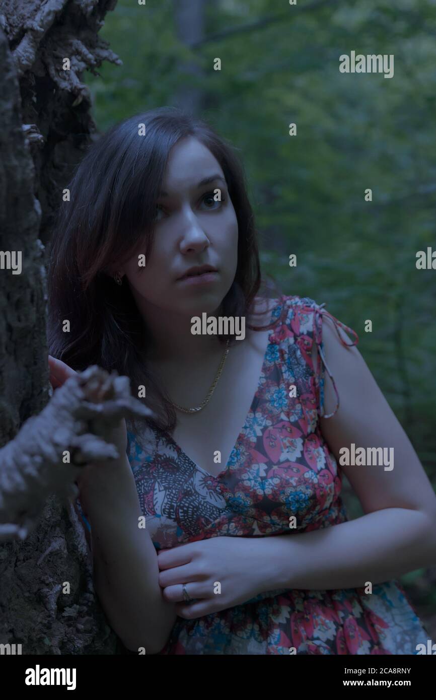Scared young woman a forest at night Stock Photo - Alamy