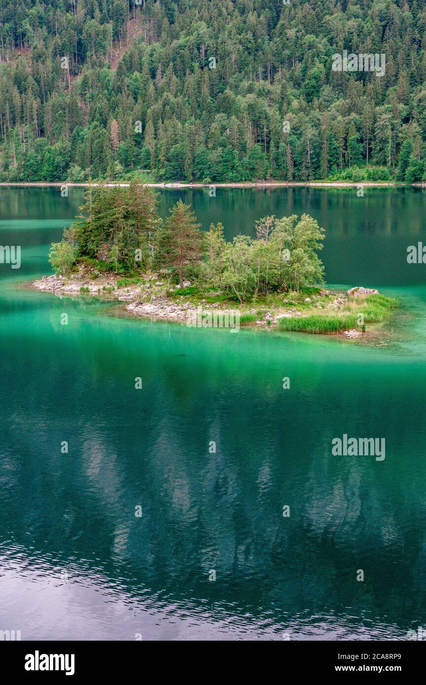 Small islands with pine-trees in the middle of Eibsee lake with ...