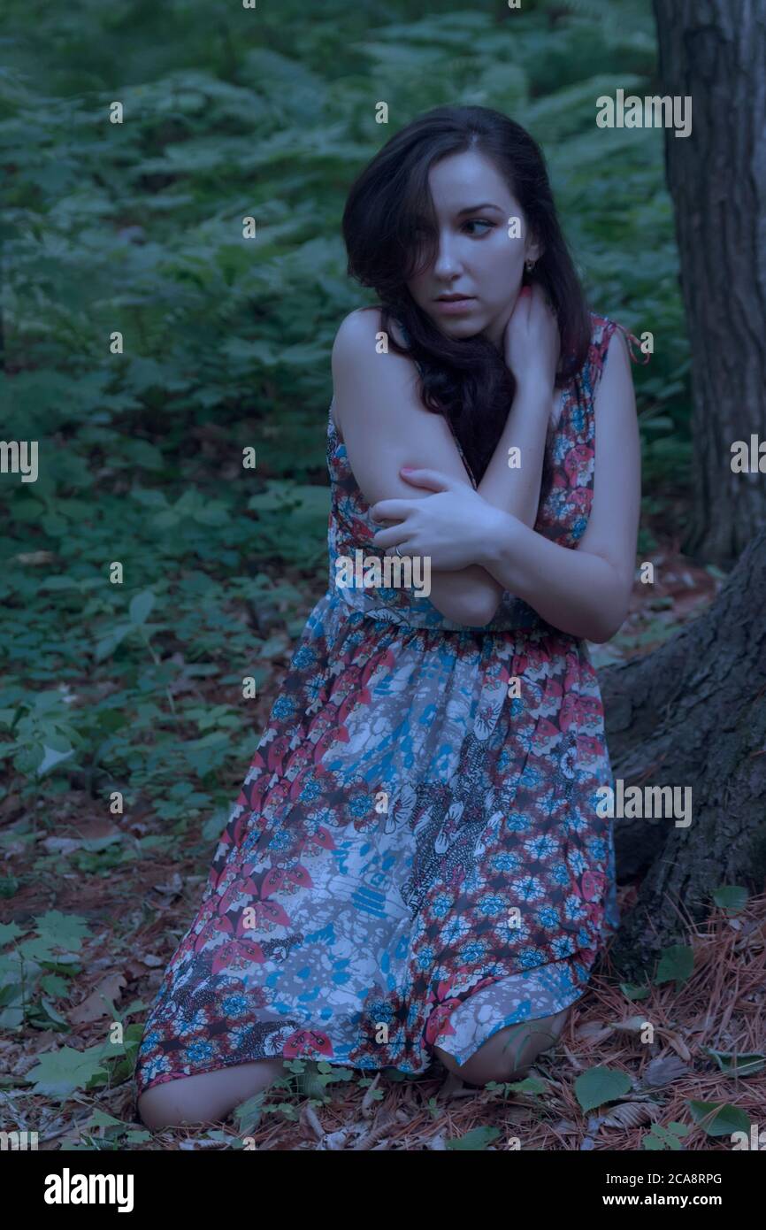 Scared young woman a forest at night Stock Photo - Alamy