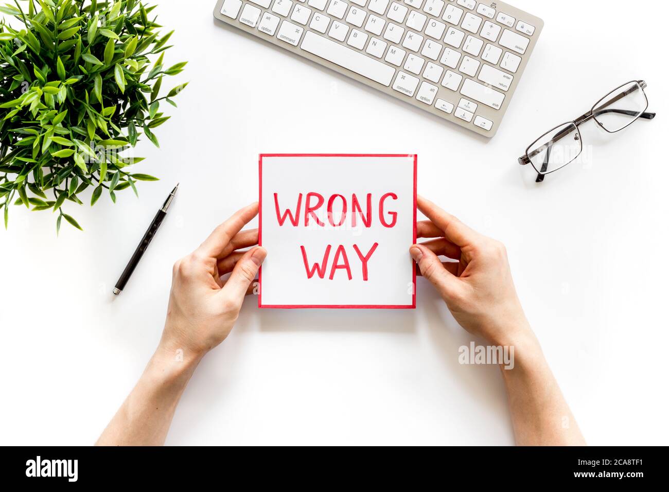 Business failure. Wrong way icon in hands on office desk top-down Stock ...