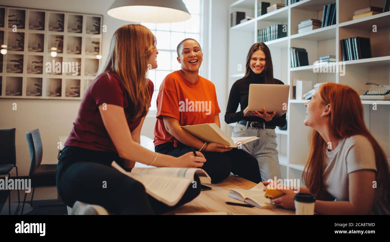 Students discussing while working on class assignment together. Young ...