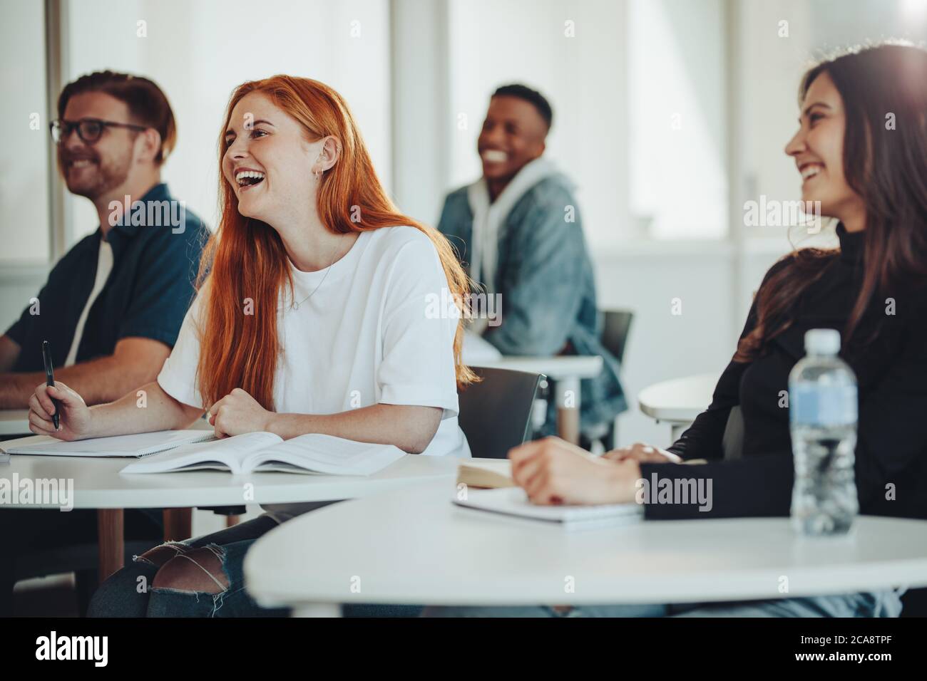 Group of multi-ethnic student sitting in the class and smiling during ...