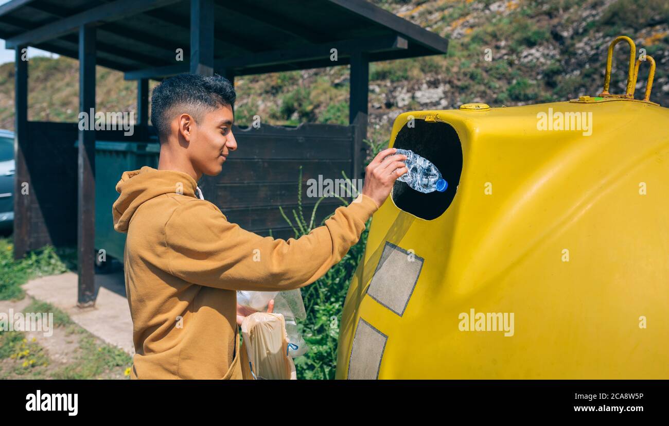 Man throwing garbage to container Stock Photo - Alamy