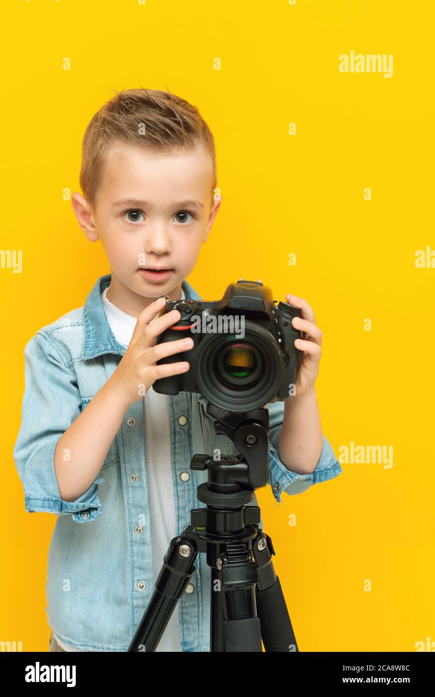 Little boy posing with digital camera on tripod Stock Photo - Alamy