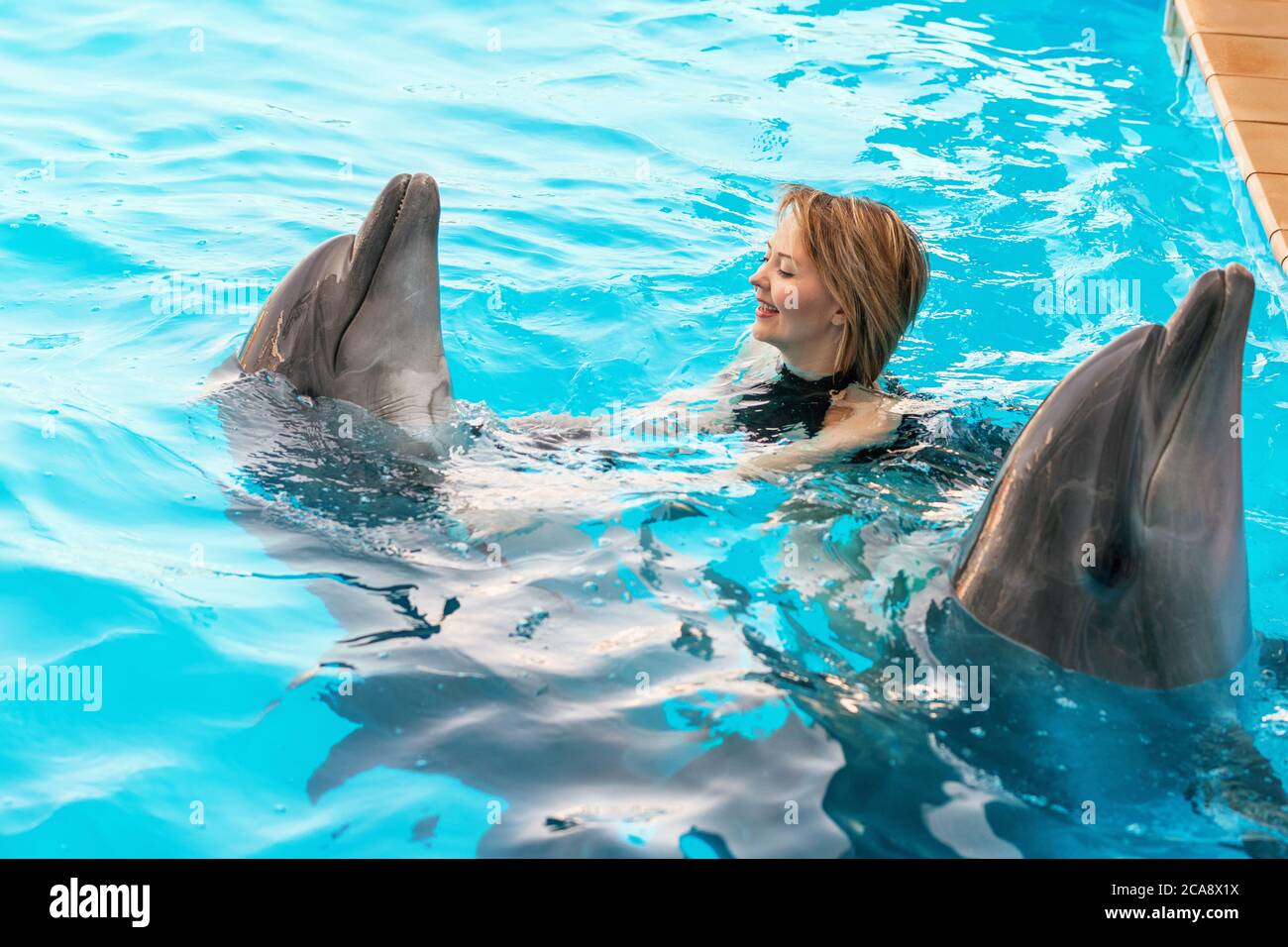 Girl riding dolphin hi-res stock photography and images - Alamy