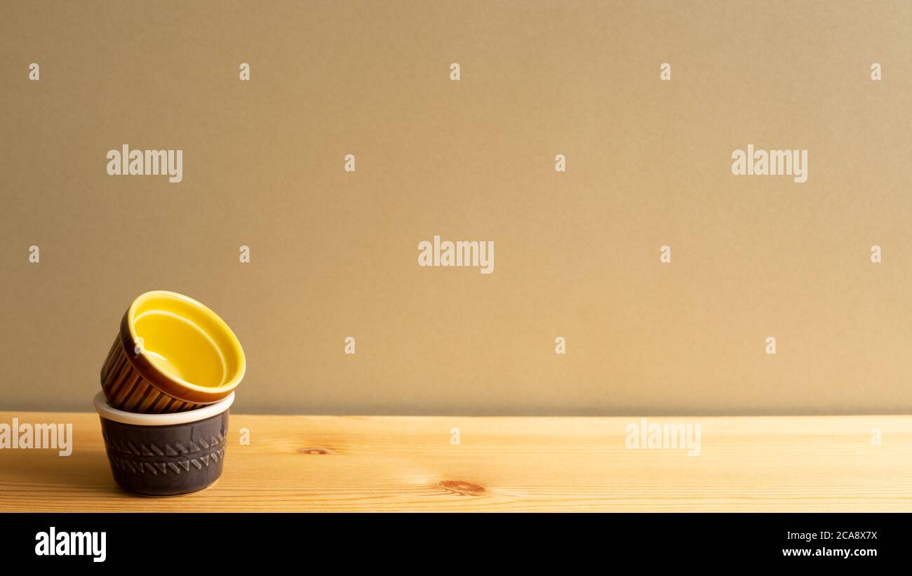 Stack of ceramic bowls on wooden table with brown background Stock ...