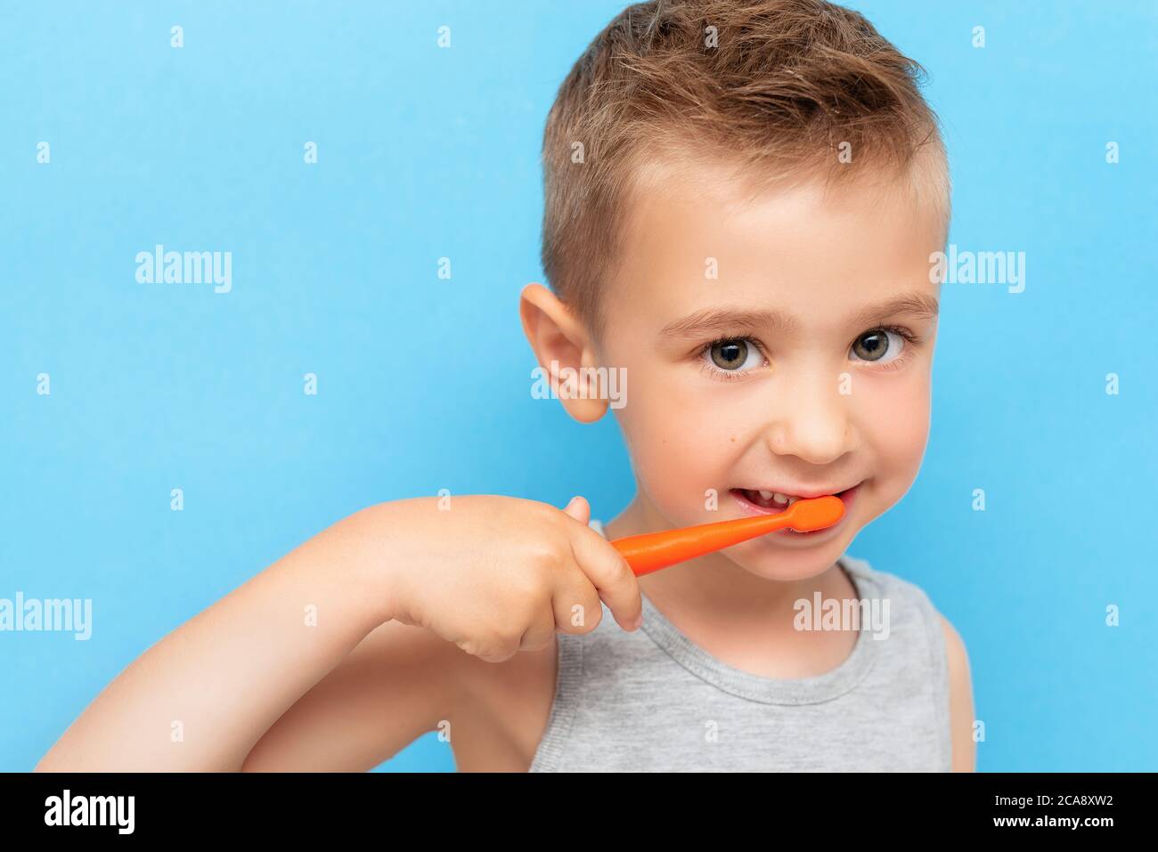 Cute little boy brushing teeth with manual toothbrush. Headshot on a ...