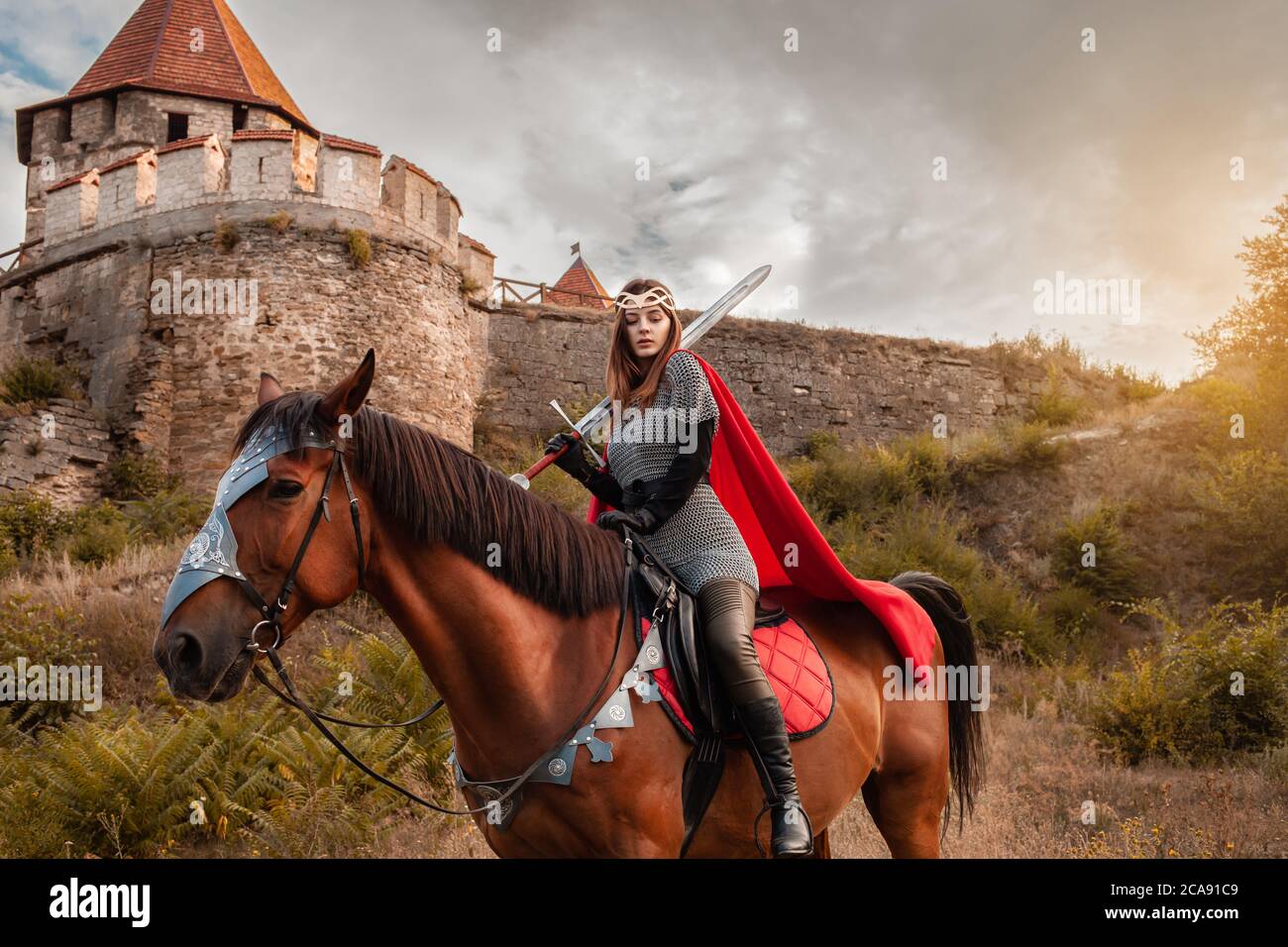 A beautiful girl with a sword in a medieval fantasy suit. A woman in a ...