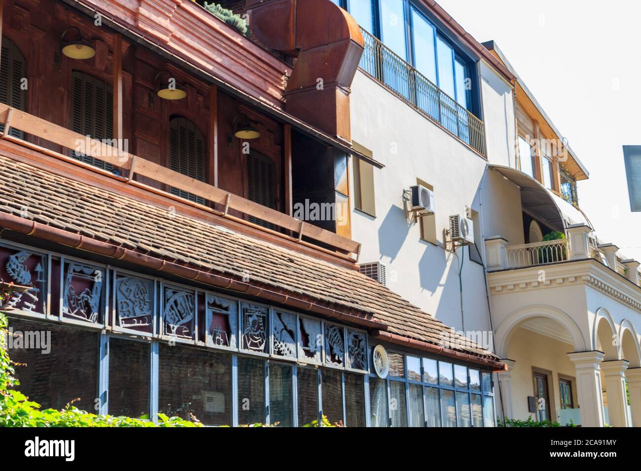 Traditional carved balconies and colorful houses in the Old Town of ...
