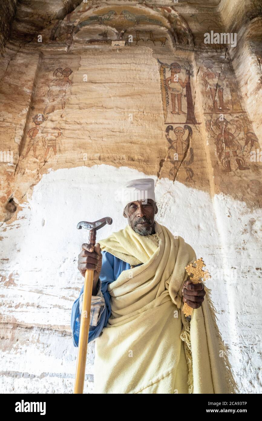 Orthodox priest holding the hand cross and prayer stick in Maryam ...