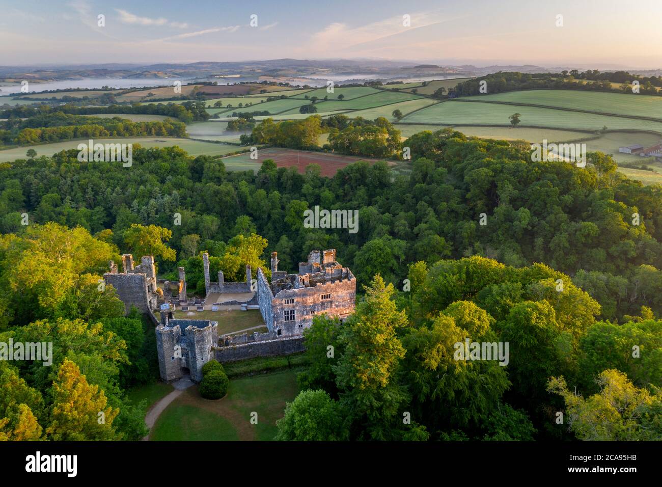 Aerial photograph of Berry Pomeroy Castle at dawn in spring, Devon ...
