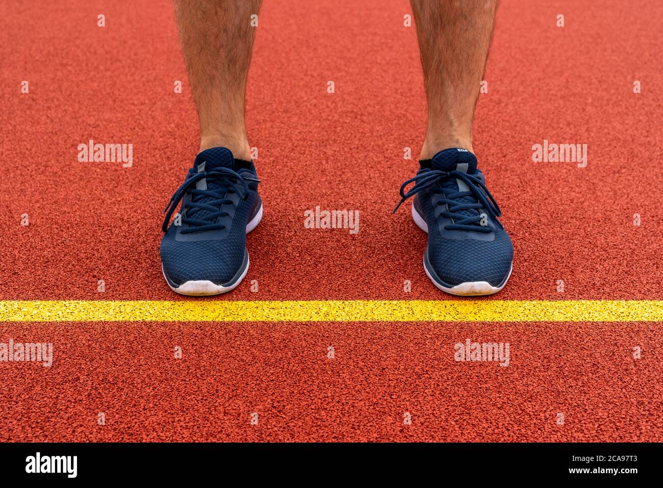 Start and challenge concept. Man standing behind the yellow line in the ...