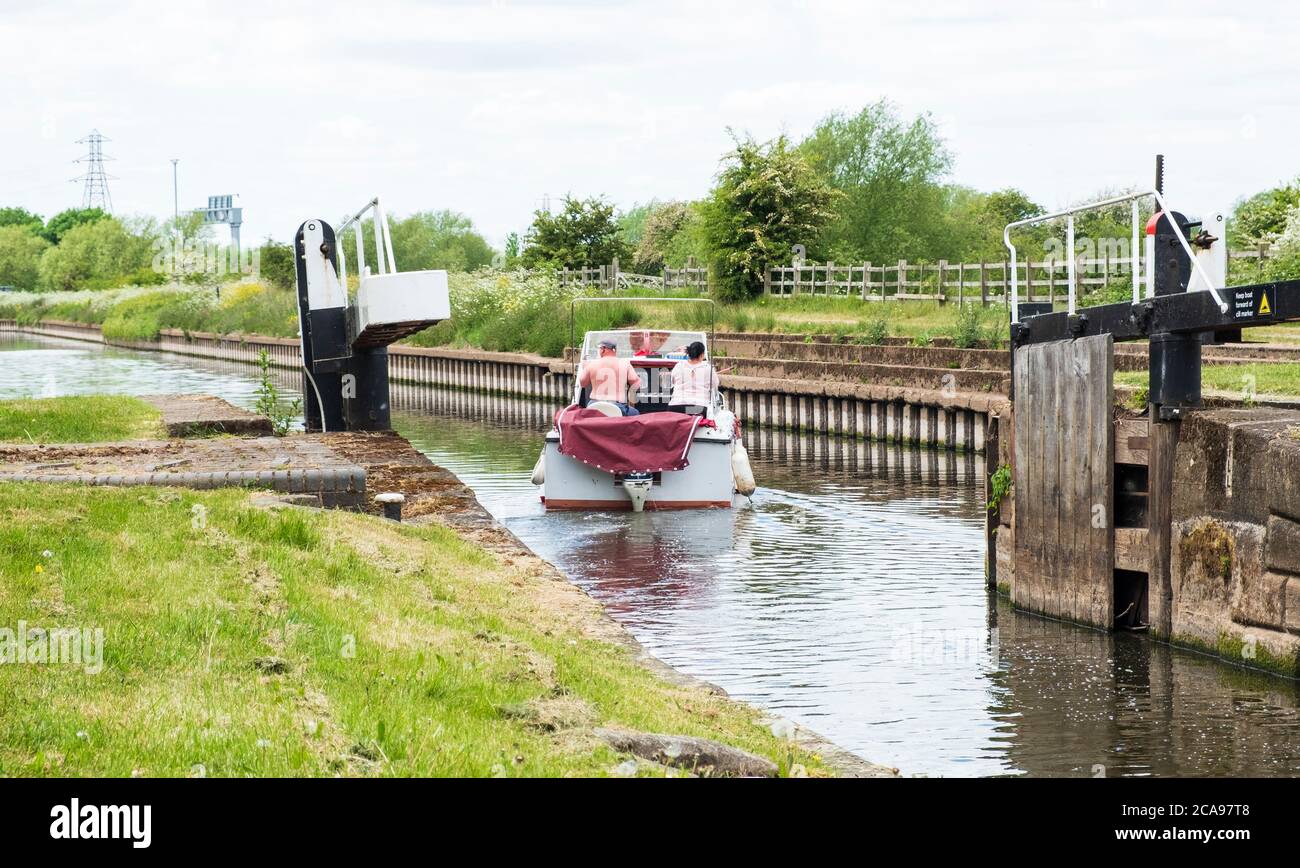 Small boat exiting a canal lock Stock Photo - Alamy