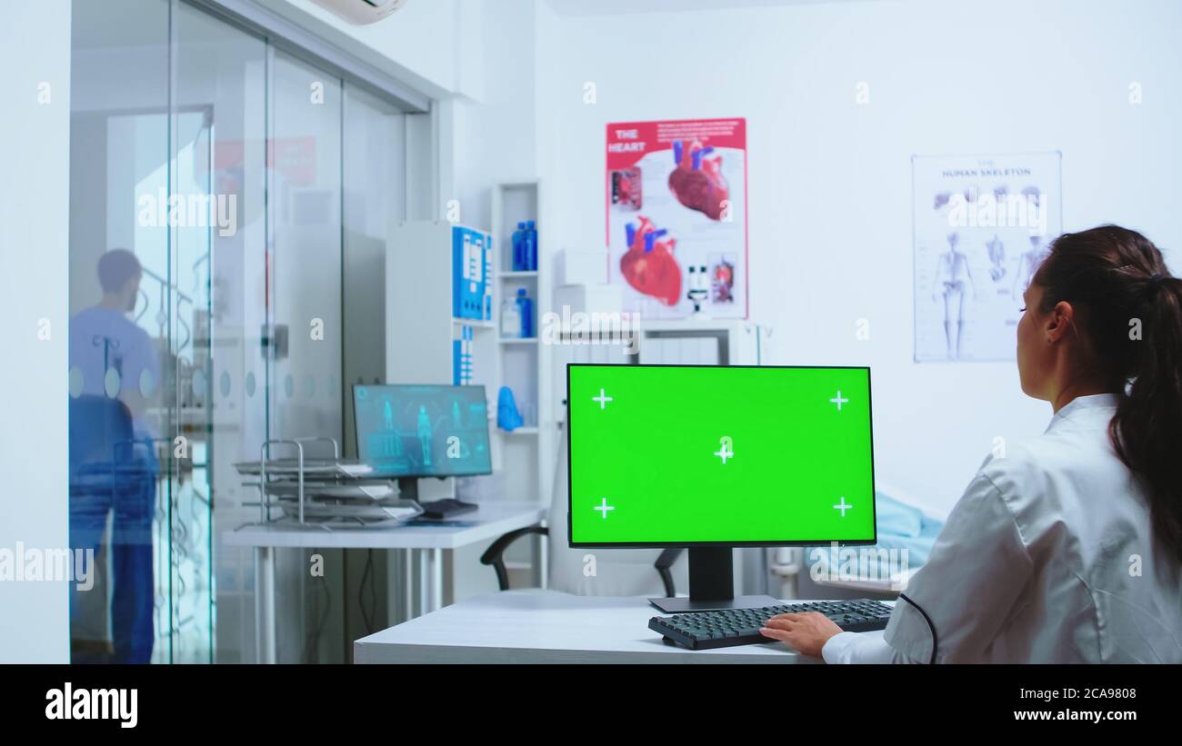 Nurse in blue uniform leaving hospital cabinet and doctor using ...