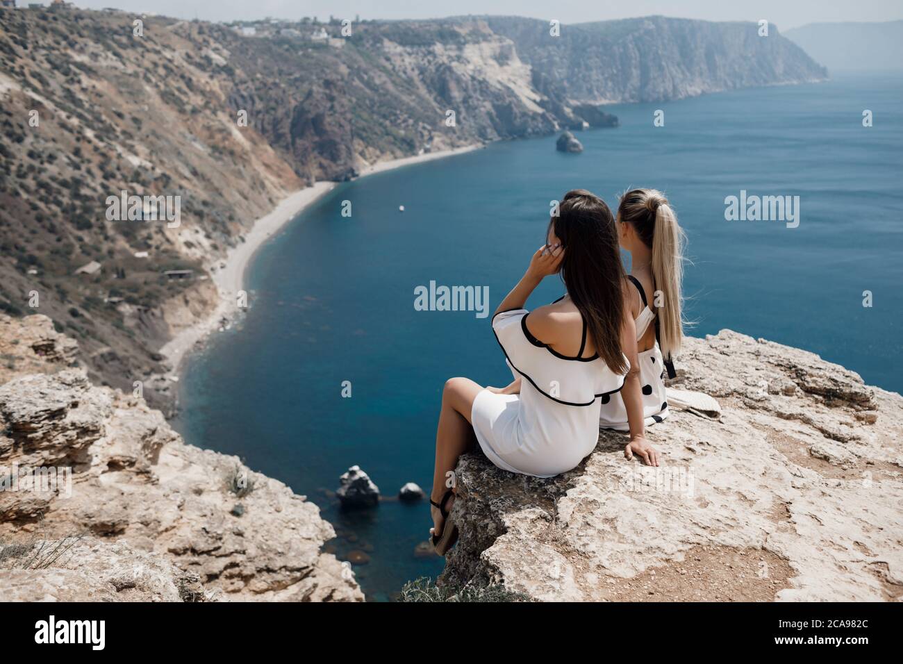backside portrait of a two beautiful women outdoor at paradise place ...