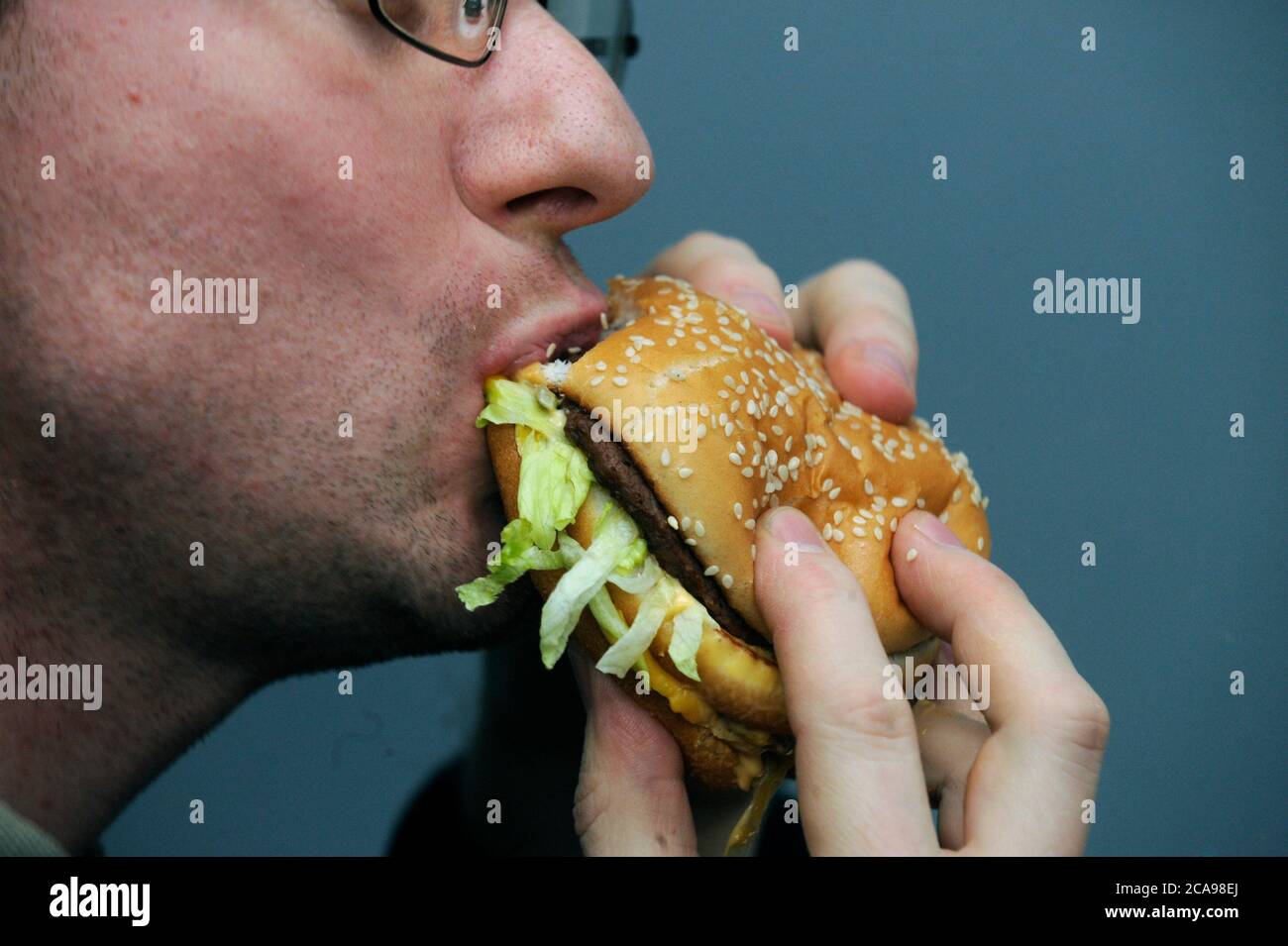 A man eats Big Mac hamburger of McDonald's in Prague, Czech Republic ...