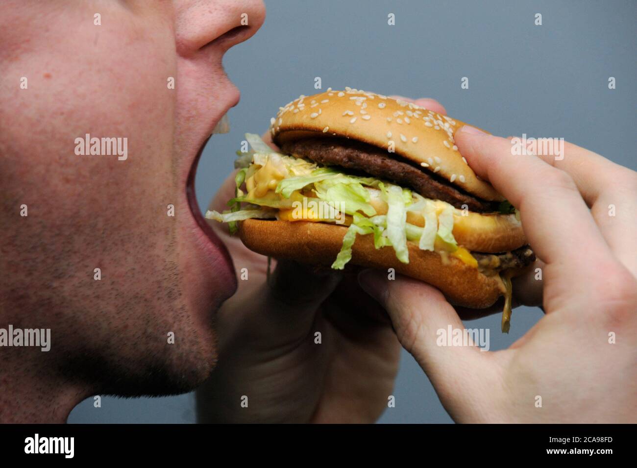 A man eats Big Mac hamburger of McDonald's in Prague, Czech Republic ...