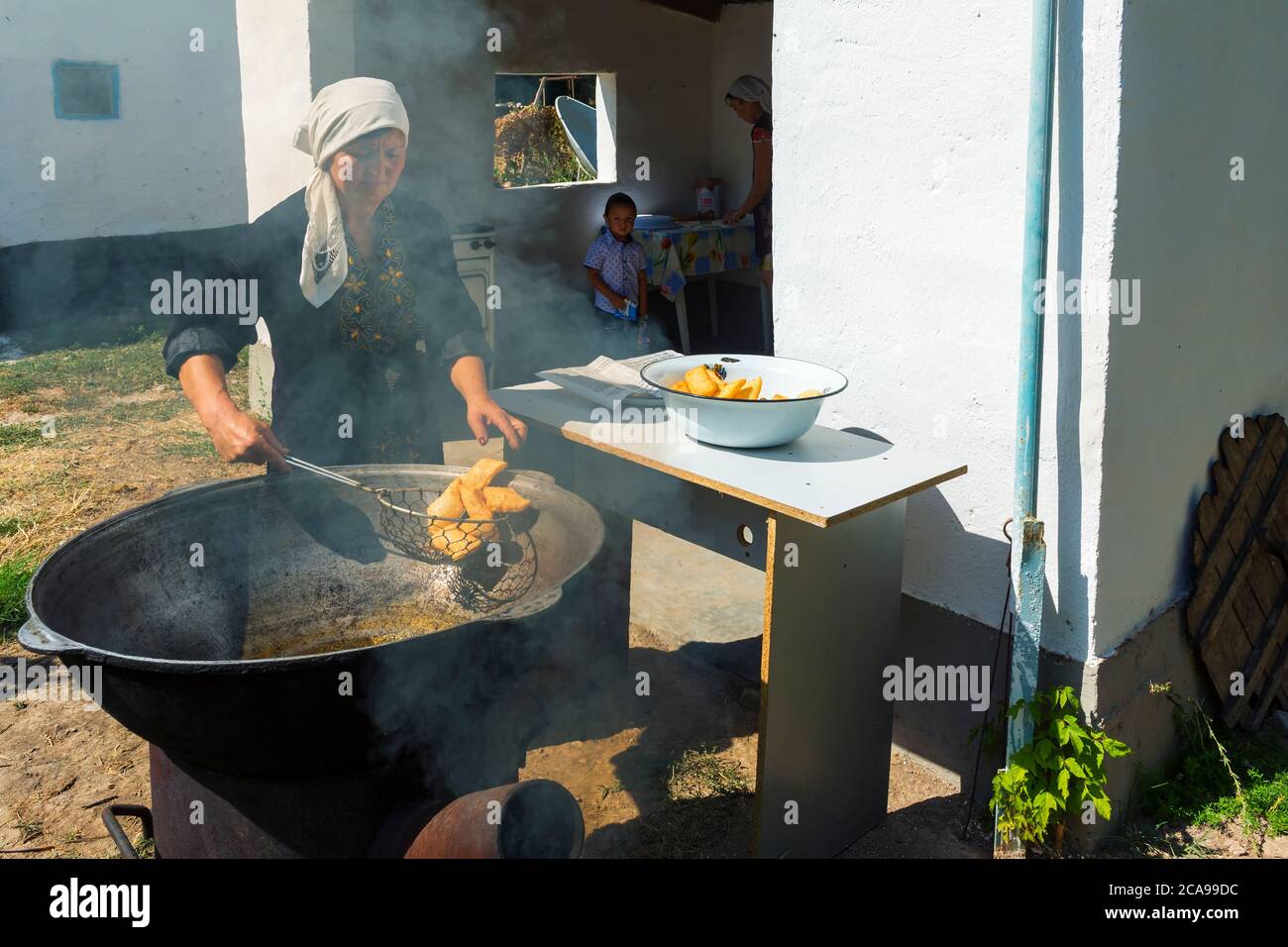 Kazakh Woman preparing the traditional local tandyr bread, Shymkent ...