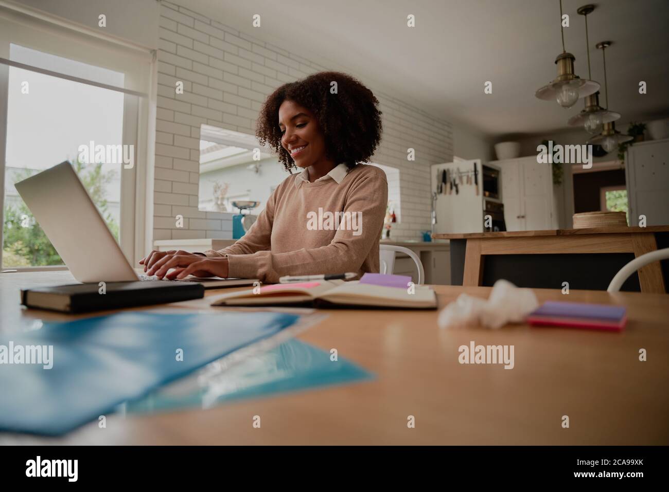 African successful entrepreneur working at home using laptop while ...