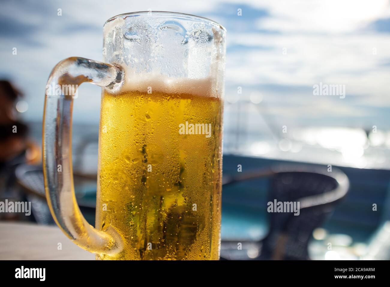 Cold Beer on a beach in big glass Stock Photo - Alamy