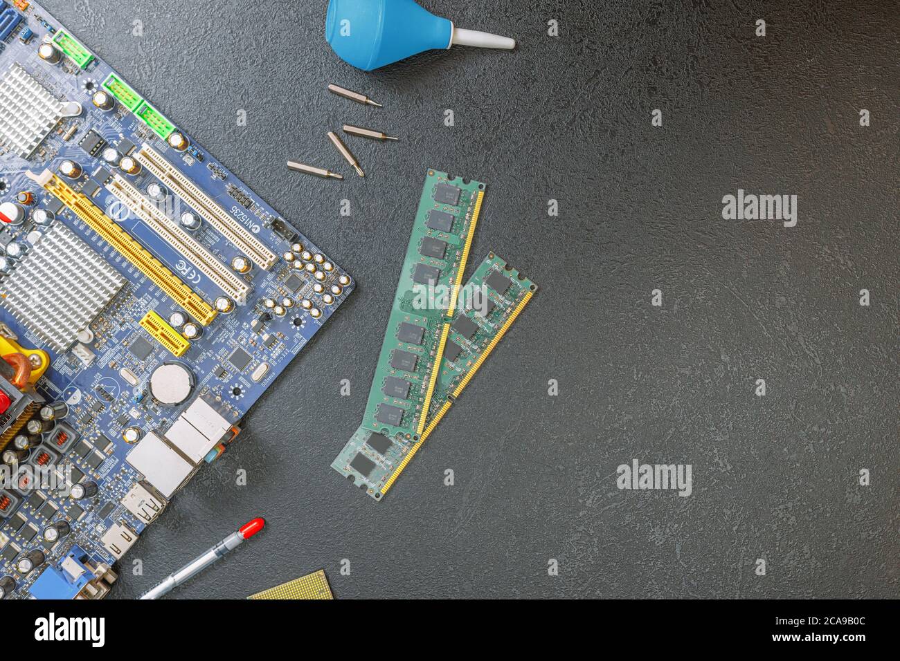 computer motherboard two RAM slots, on the table repair equipment ...