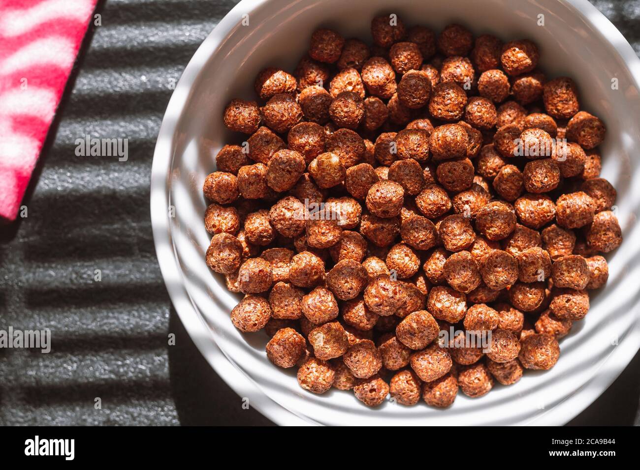 Chocolate balls cereal breakfast light through top view blinds Stock ...