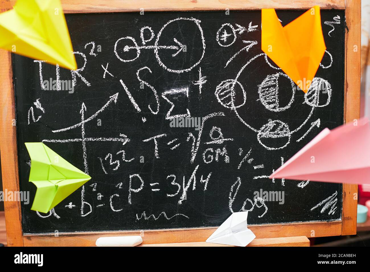 school concept, colored paper planes fly near the school board ...