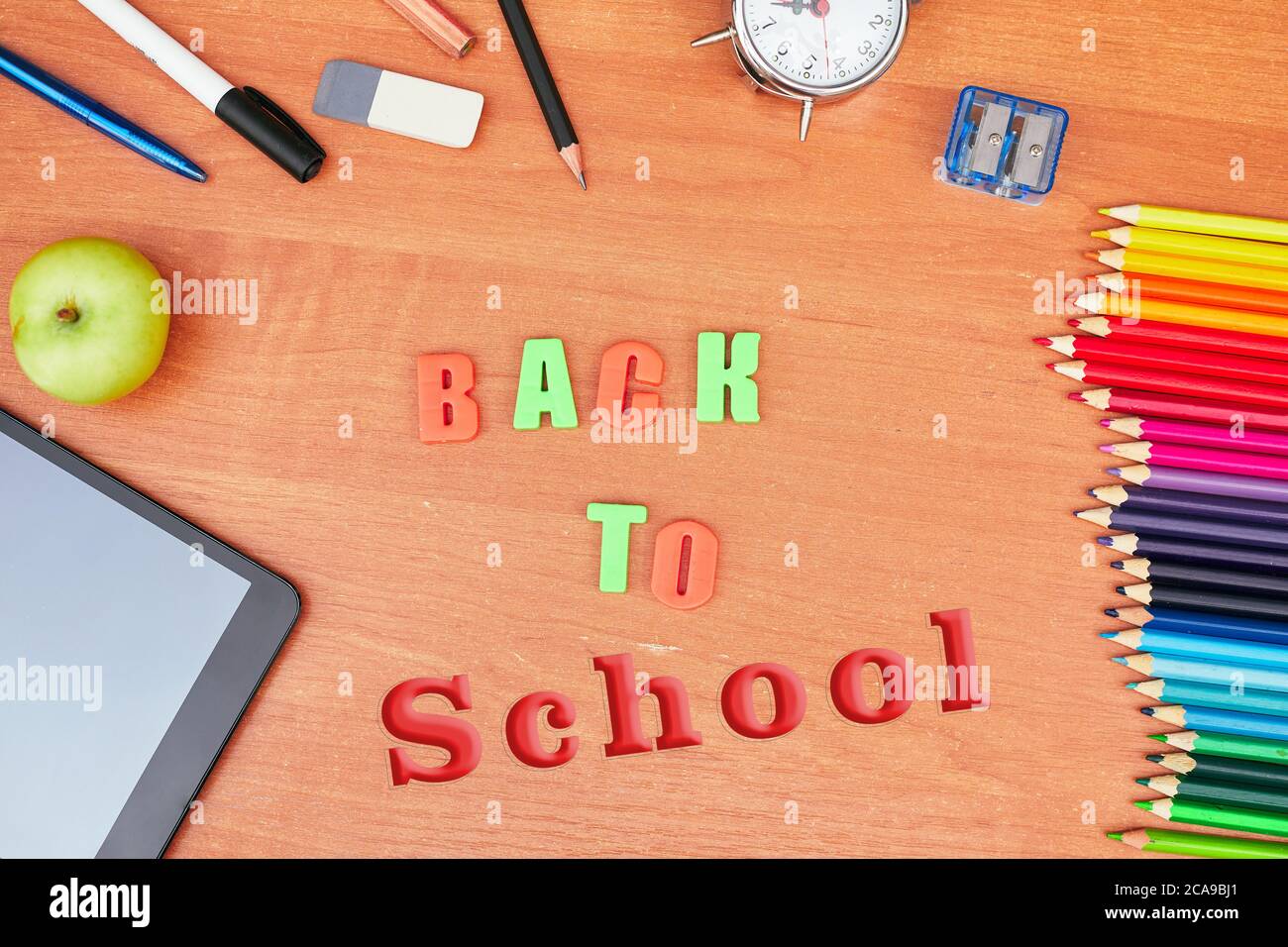 back to school lettering, concept, stationery on desk and tablet ...