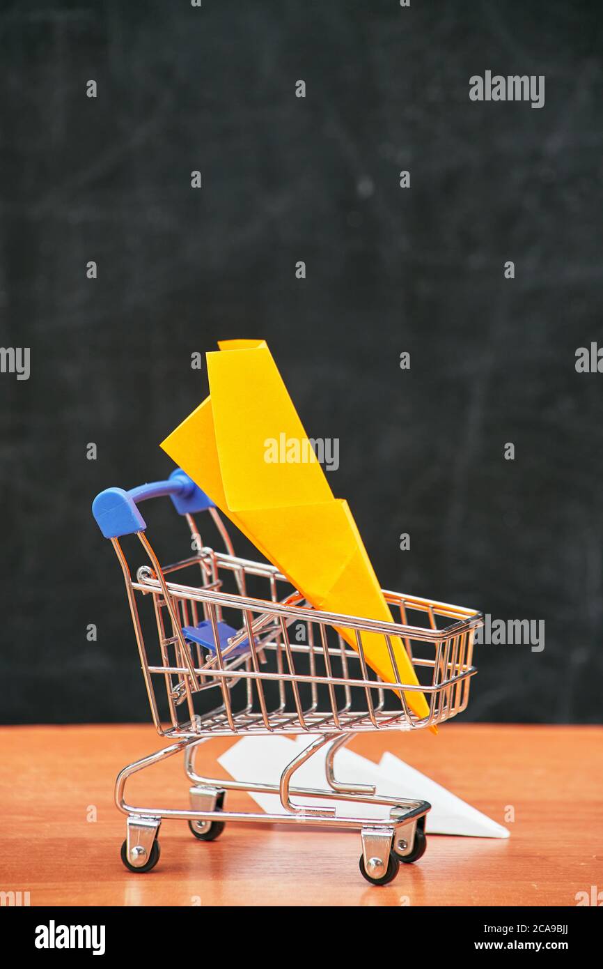 back to school concept, shopping cart with paper plane on school board ...