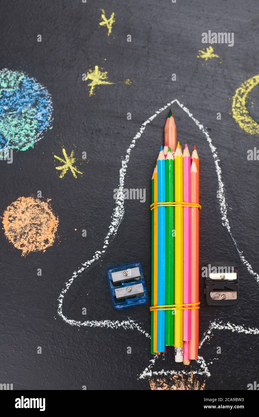 Back to school with a rocket made from pencils on a school board ...