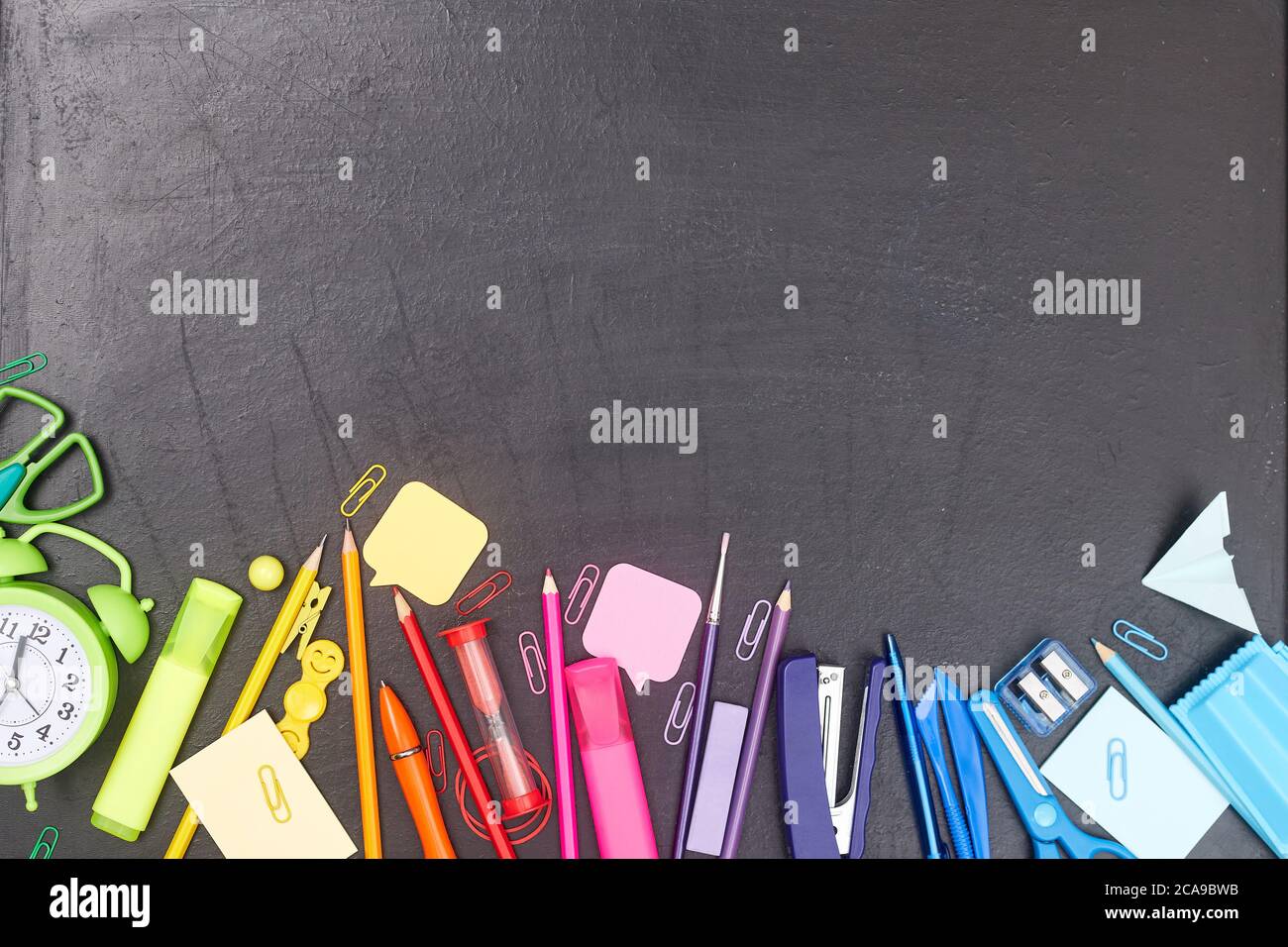 back to school, multicolored school supplies, rainbow on black school ...