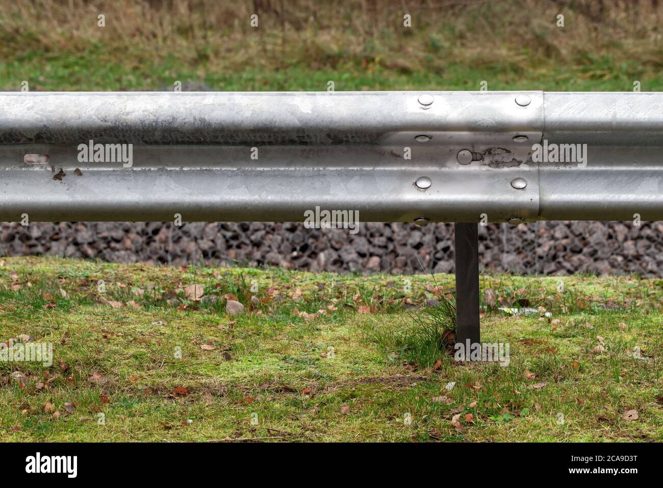 Metal guardrail mounted on a highway roadside Stock Photo - Alamy