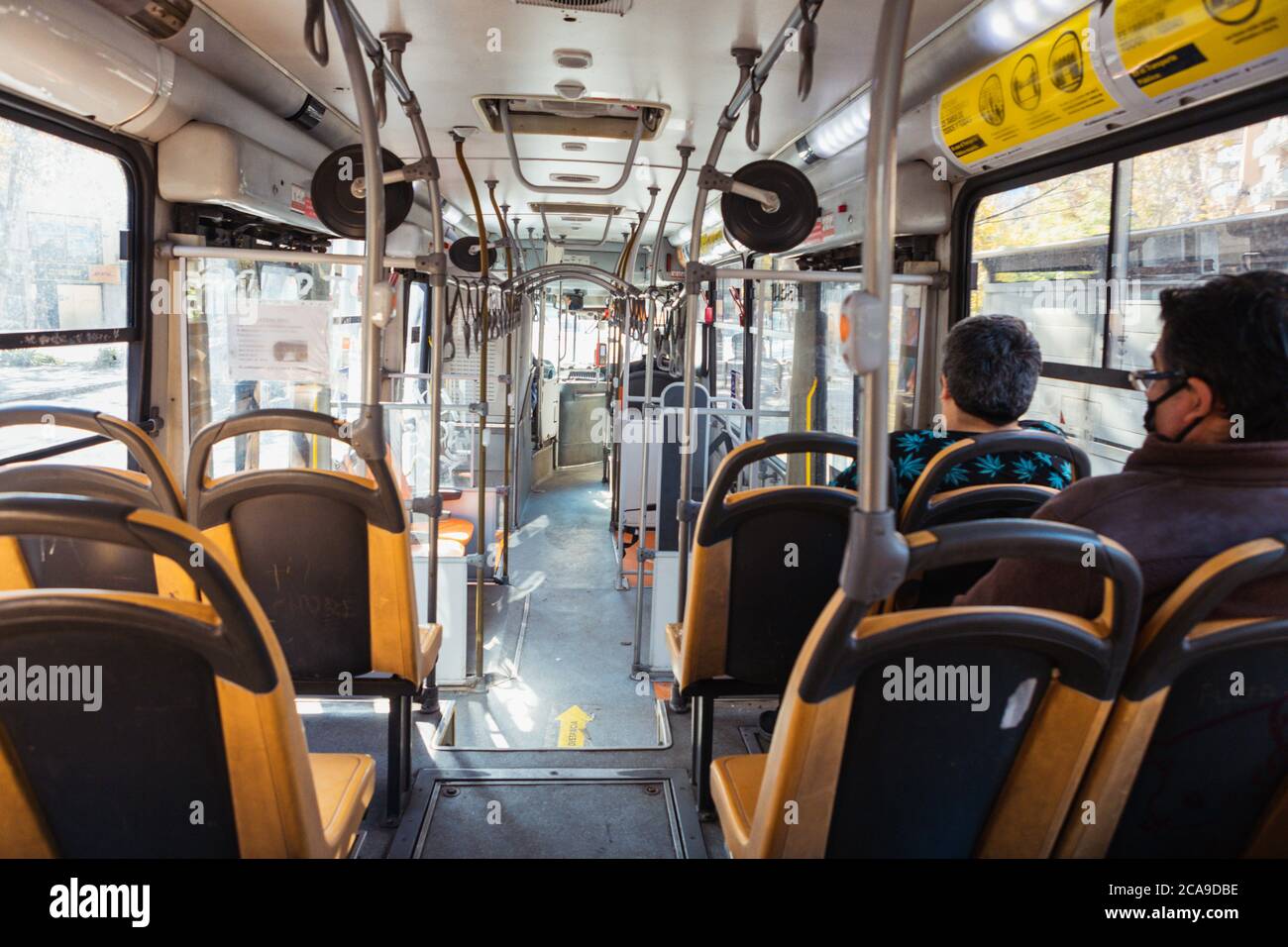Inside of a half-empty bus with two passengers - concept of new normal ...