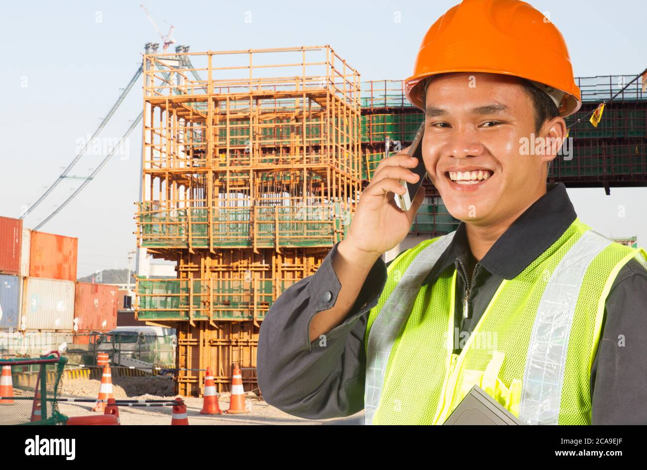 Construction worker talking with handphone on location site Stock Photo ...