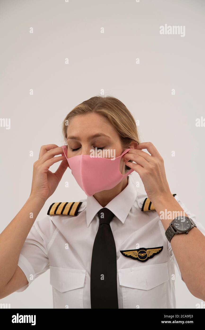 Wiltshire, England, UK. August 2020. Airline pilot wearing a face mask ...
