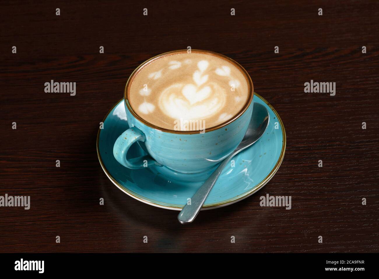 Cup of latte coffee on a wooden table with a teaspoon. Photos for ...