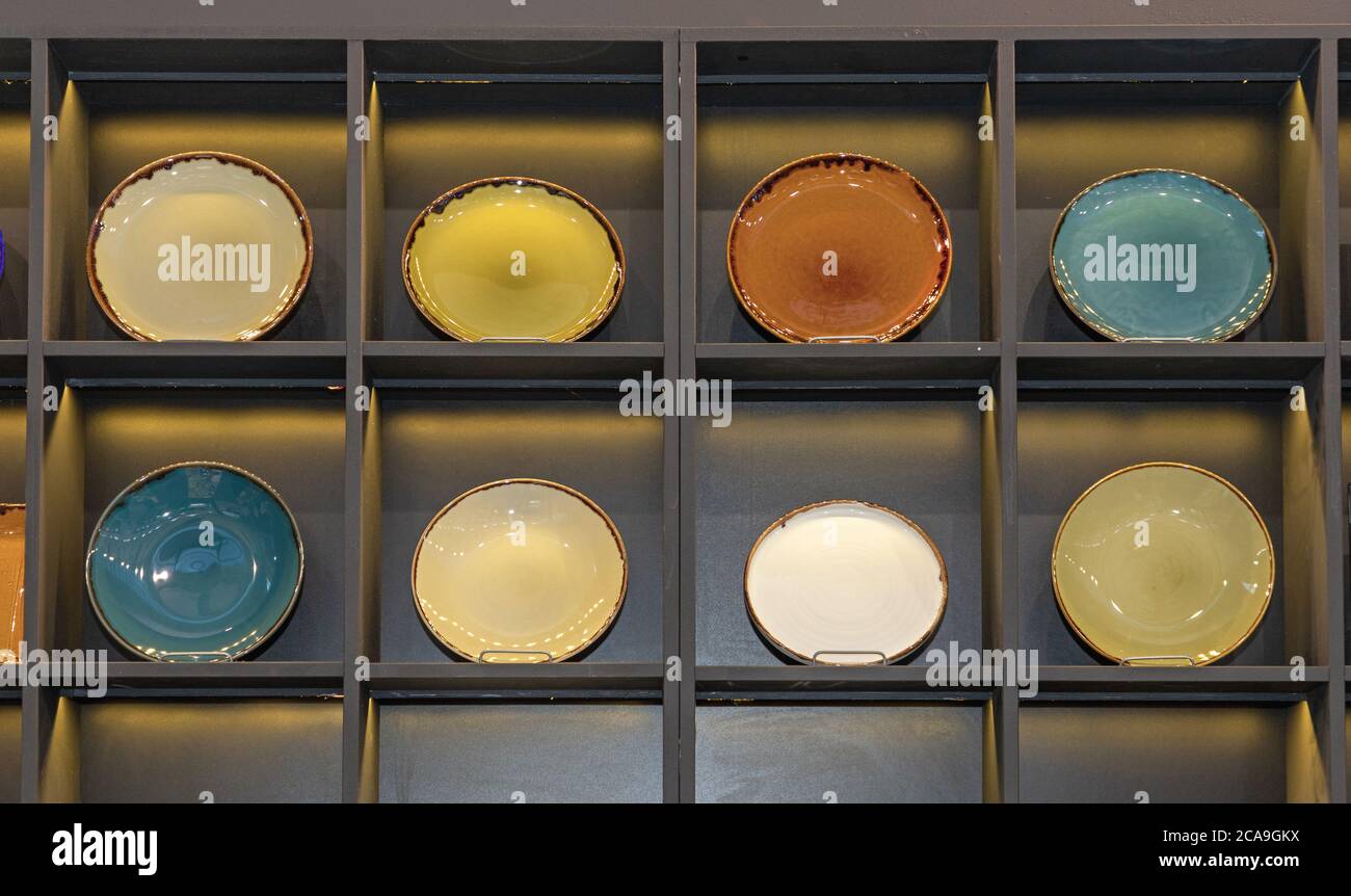 Many Colourful Dish Plates at Shelf Display Stock Photo - Alamy