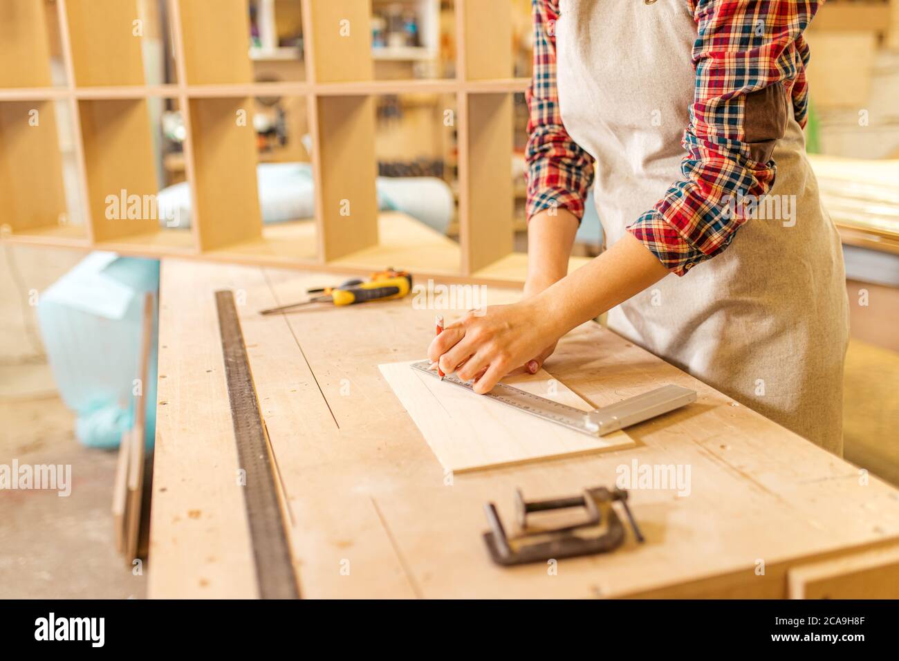 attractive caucasian carpenter lady deals with drawings during work ...