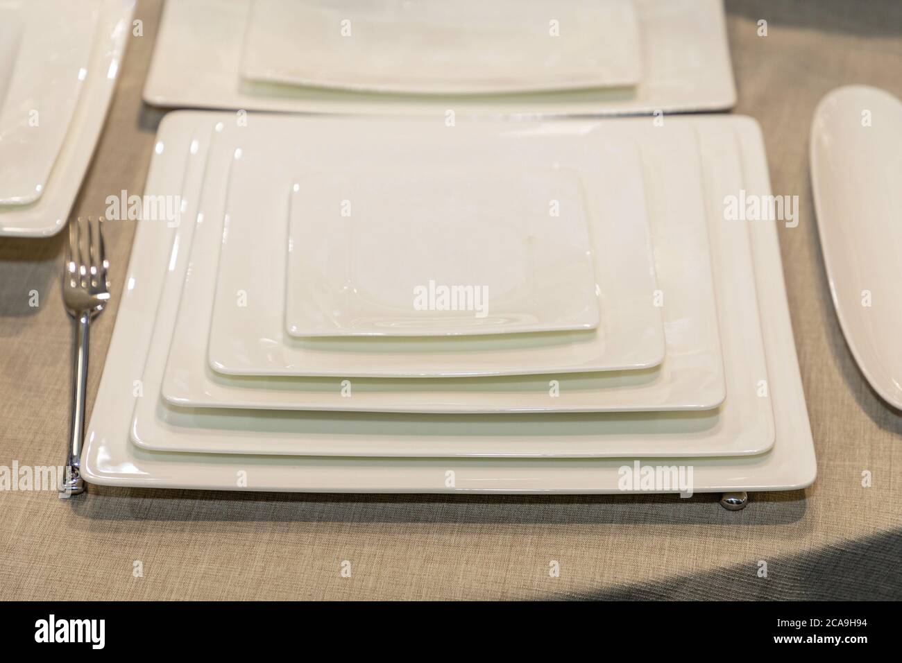 Square Shape Plates at Dining Table Setup Stock Photo - Alamy