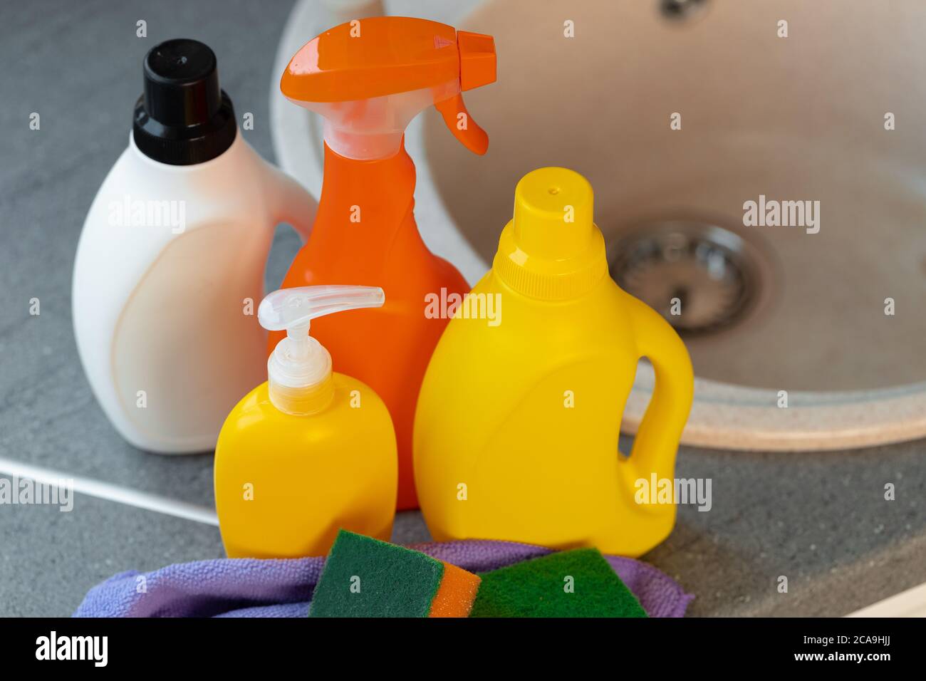 Household chemicals product bottles standing near the kitchen sink ...