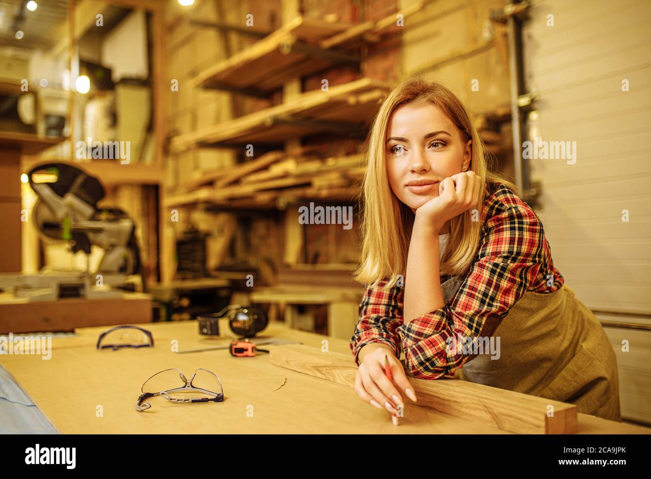 side view on beautiful woman after work, female work as carpenter in ...