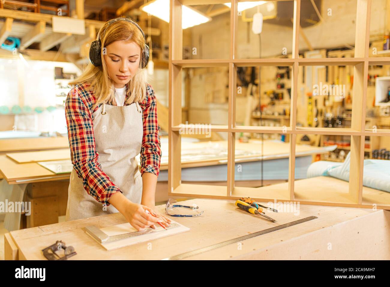 attractive professional woodworker or craftswoman during work in ...