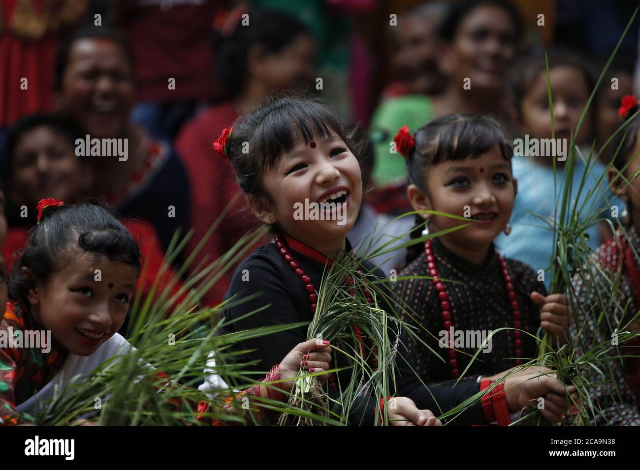Lalitpur, Nepal. 5th Aug, 2020. Girls in traditional attire participate ...