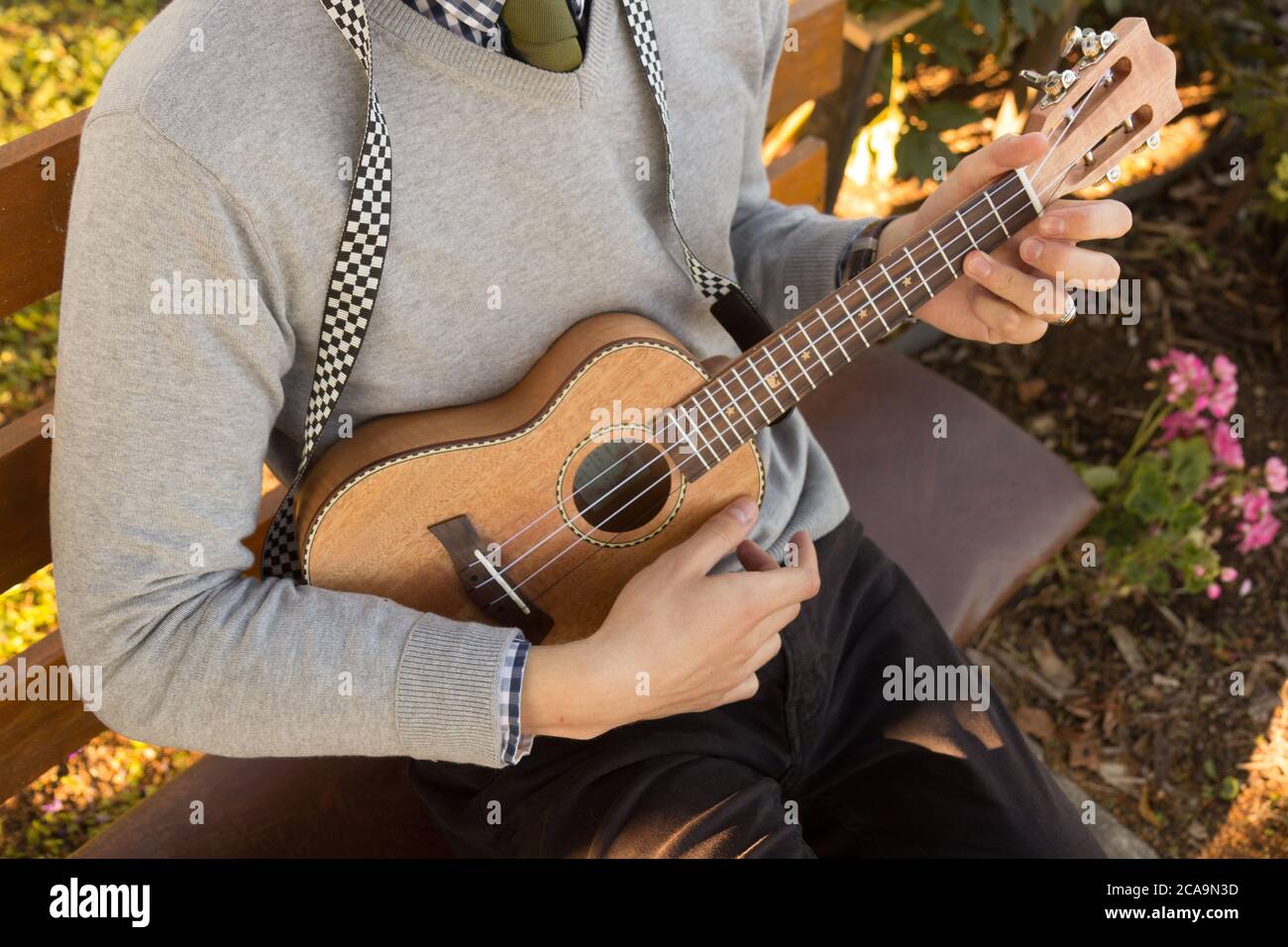 Young man playing ukulele Stock Photo - Alamy