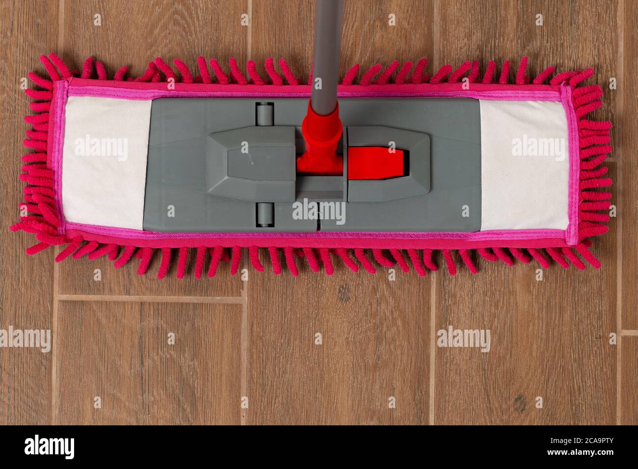 Top view of a pink mop on wooden floor Stock Photo - Alamy