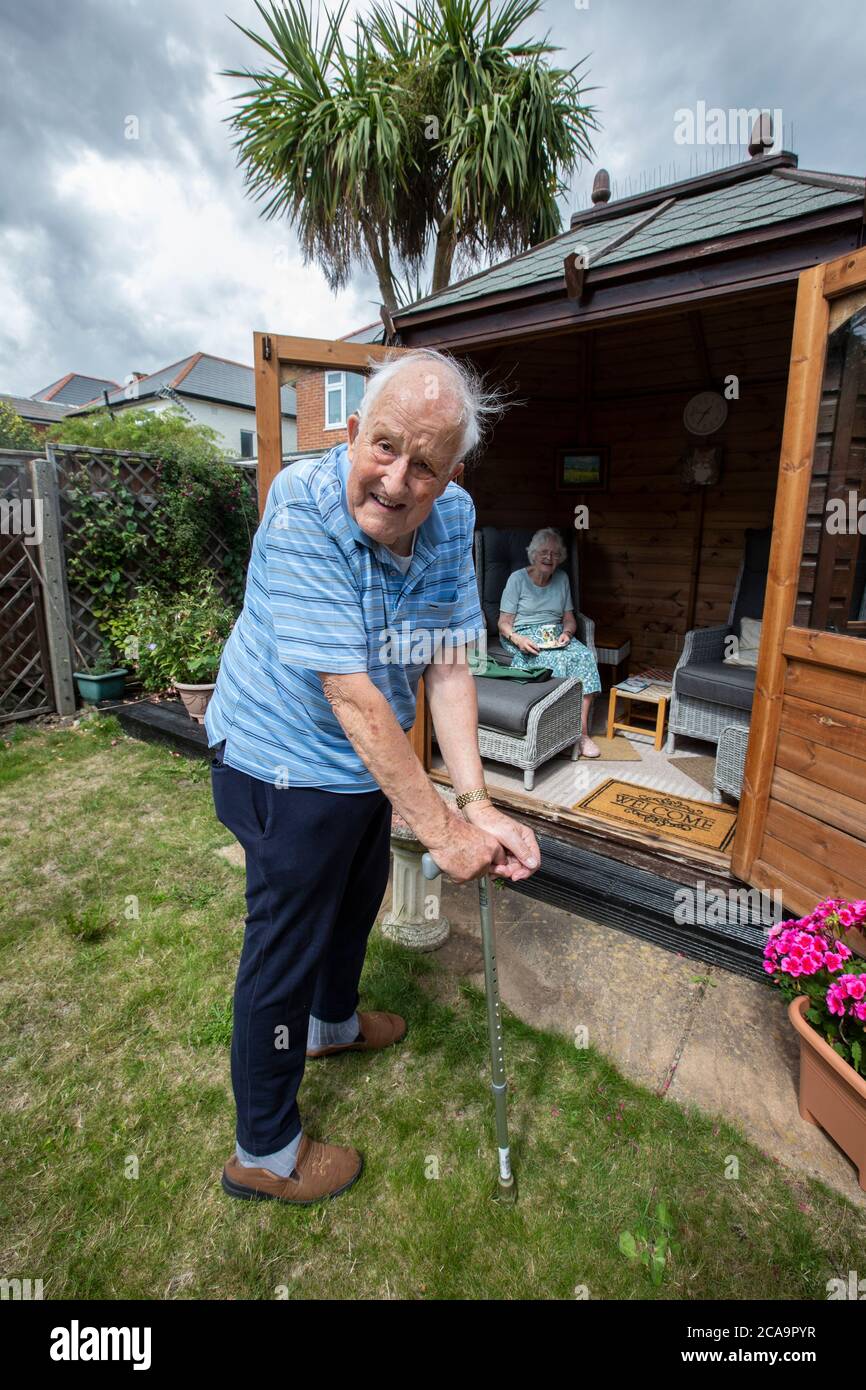 Elderly couple in their 80's enjoying the warm summer weather at their ...