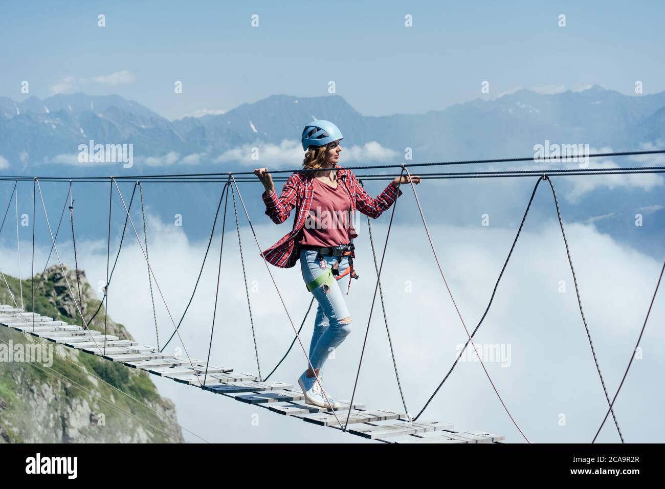 Woman hanging on rope hi-res stock photography and images - Alamy